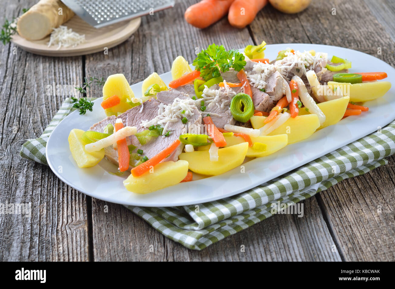 Boiled pork with mixed root vegetables and grated fresh horseradish - a ...