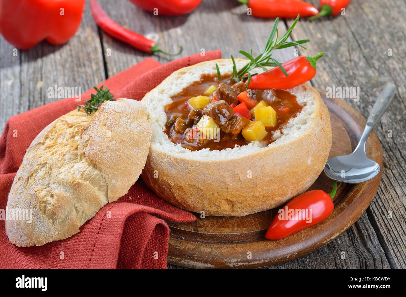 Traditional hot Hungarian goulash soup in a white bread loaf Stock ...