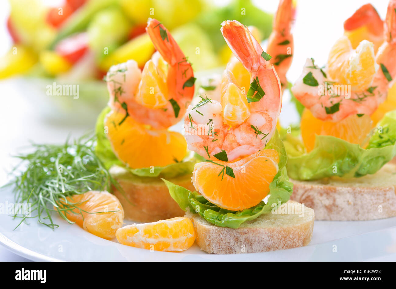 Scampi skewers with mandarin on Italian bread Stock Photo - Alamy