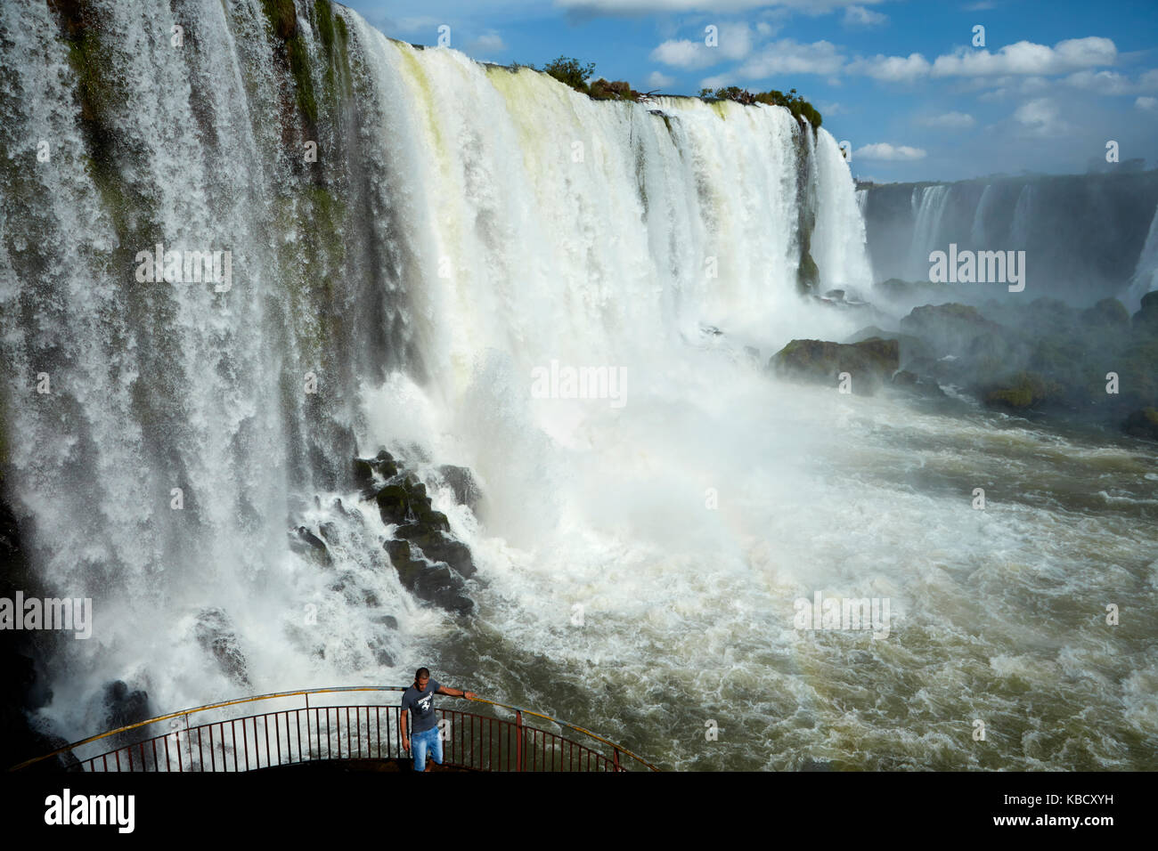 Tourist on viewing platform on Brazil side of Iguazu Falls, Brazil ...