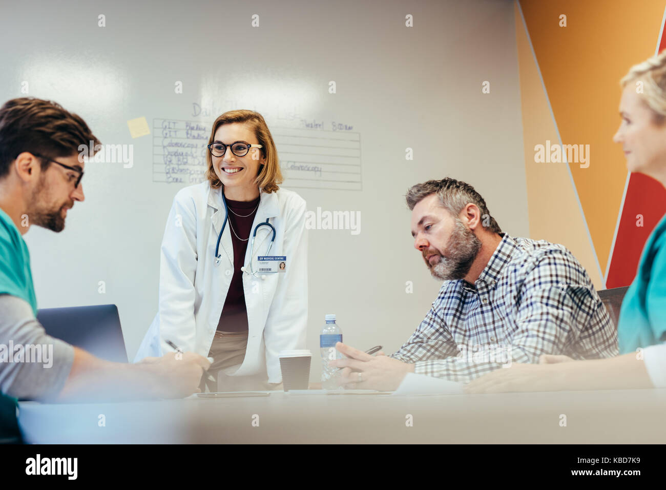 Four physicians in meeting at hospital boardroom. Hospital staff ...