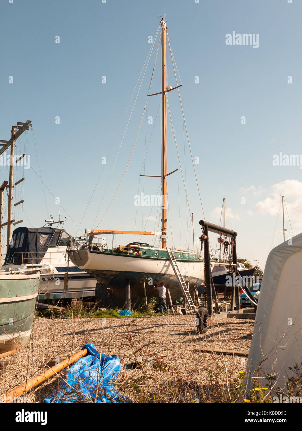 man working on boat in dock yard sunny day; essex; england; UK Stock ...