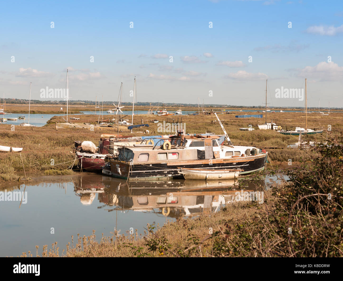 boats parked along estuary marshland in tollesbury maldon; essex ...