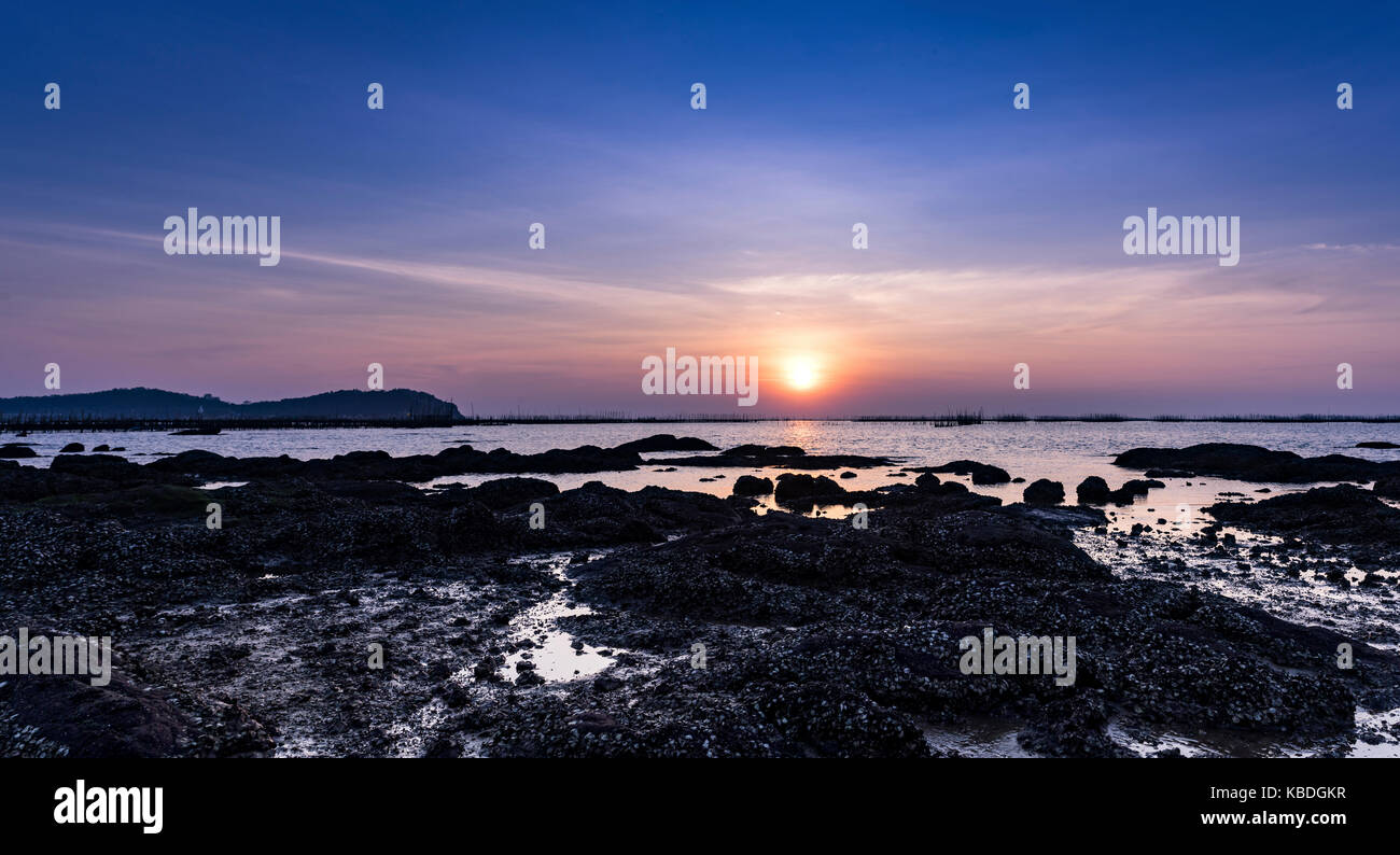 Beach with rocks in sunset time Chonburi,Thailand Stock Photo - Alamy