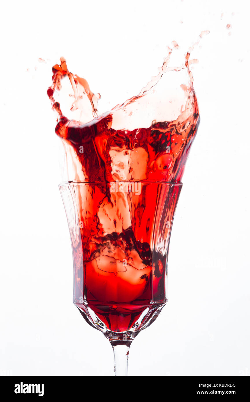Glass of splash red wine Stock Photo - Alamy