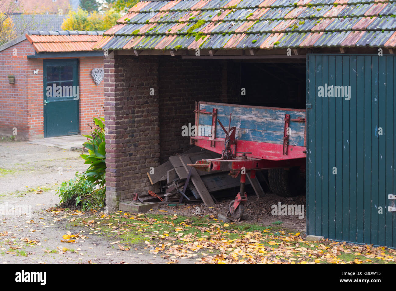 barn with agricultural vehicle in a small village Stock Photo - Alamy