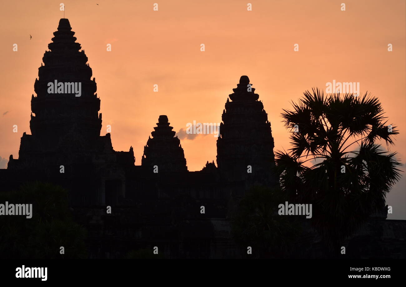 Sunrise behind mysterious towers of ancient Angkor Wat Buddhist temple ...