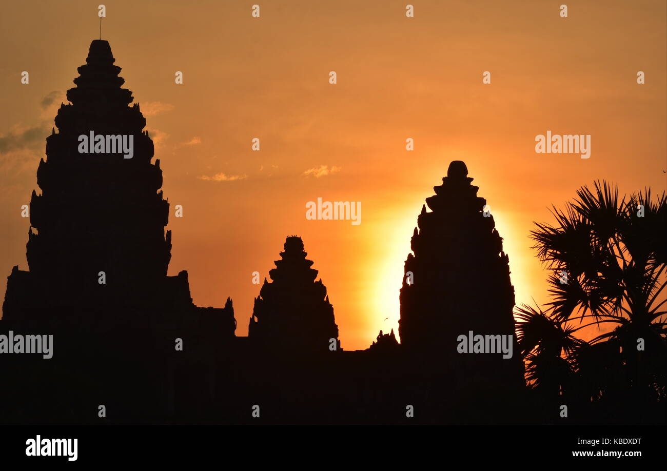 Sun rising behind the beautiful towers of the Angkor Wat ancient ...