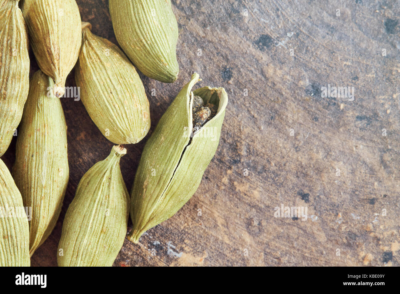 Raw green cardamom pods on rustic background. Top view with copy space ...