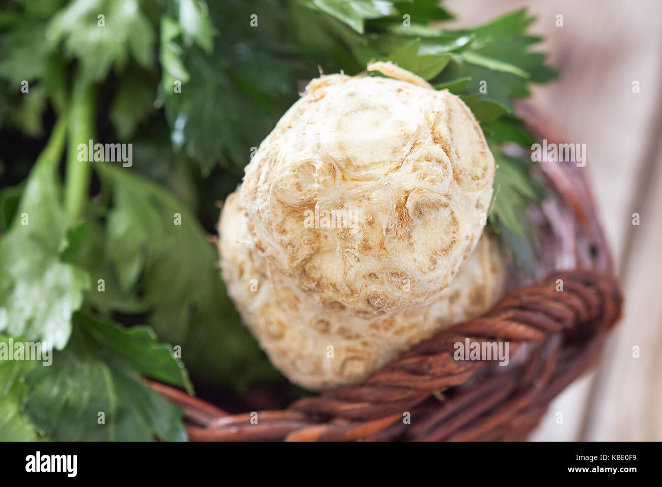 Fresh raw celery root with green leaves in woven basket Stock Photo - Alamy