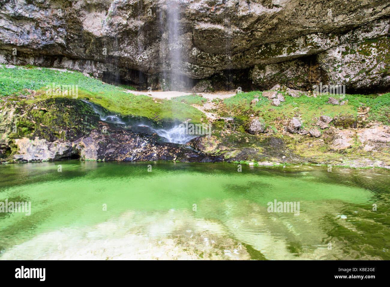 Dreamy waterfall and small emerald pond. Karst water. Fontanon of ...