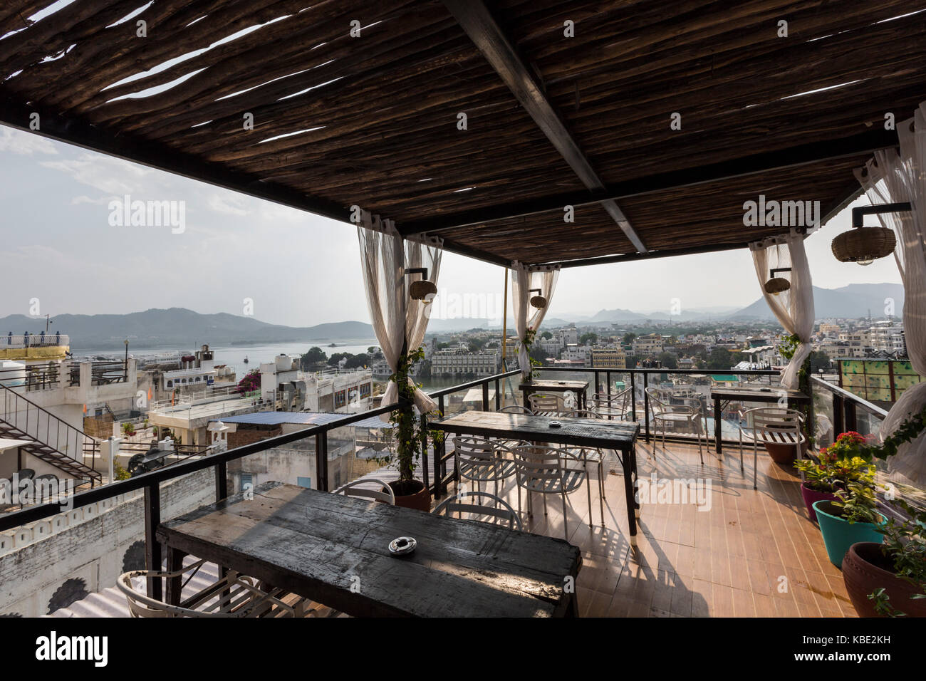 Roof top restaurant with beautiful view to Lake Pichola in the morning ...