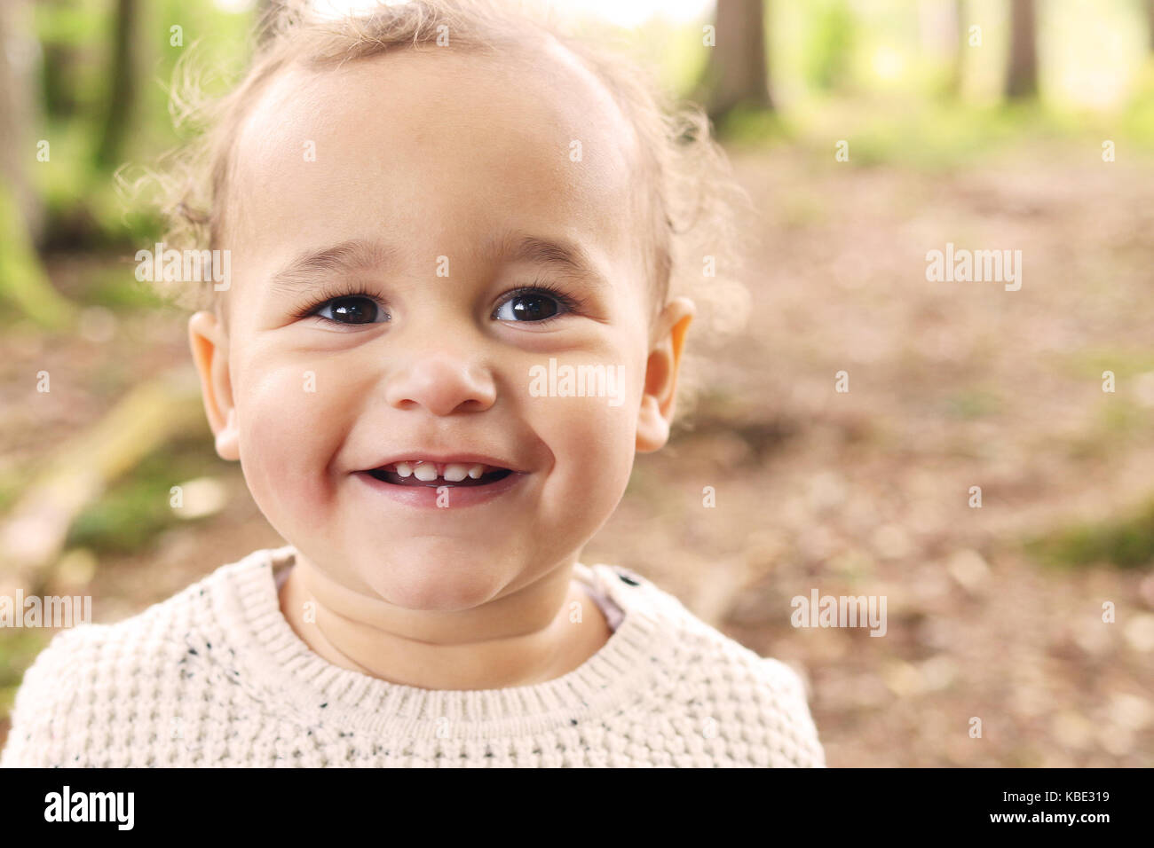 Happy child playing in a forest Stock Photo - Alamy