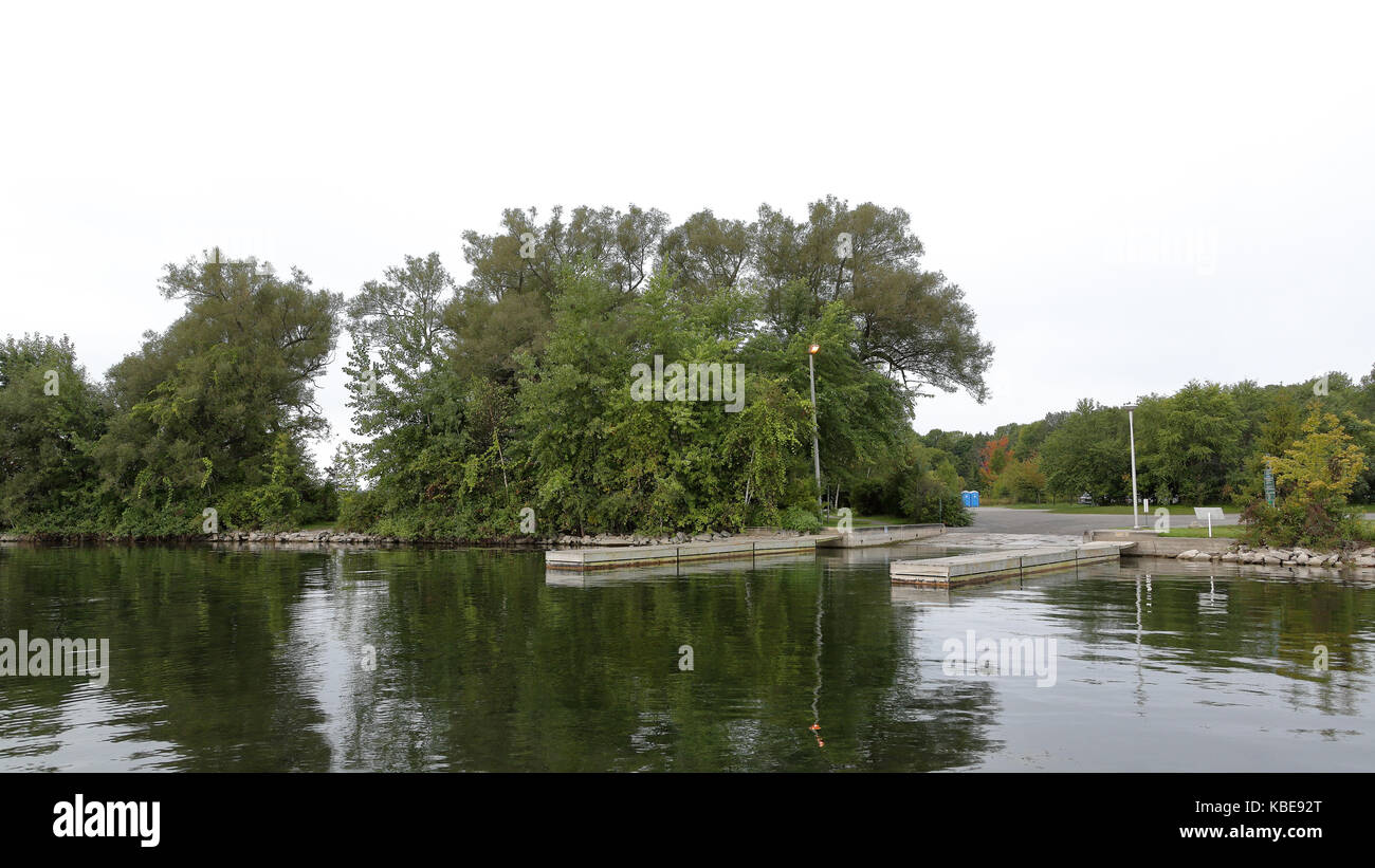 Trees, rocks and a boat launch on the shore of a bay along the St ...