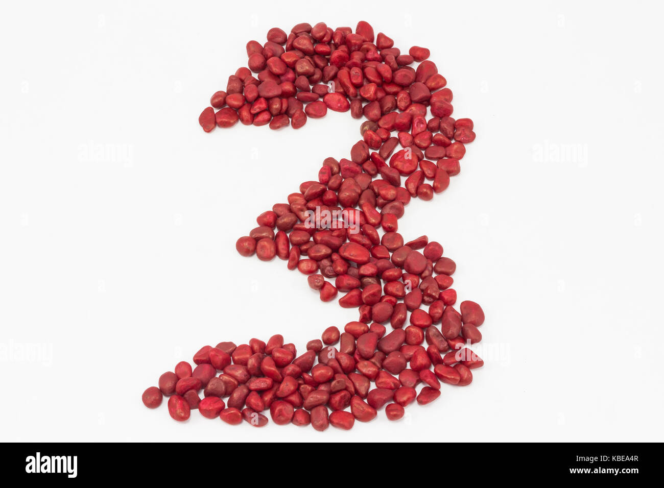 The number three made by little red stones, put one next to the other ...