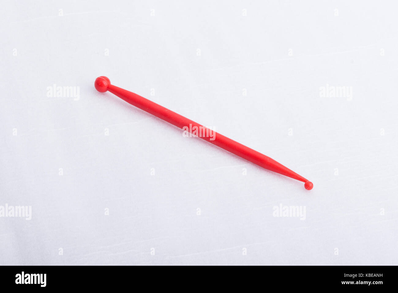 A red plastic sculpting tool on a white surface Stock Photo - Alamy