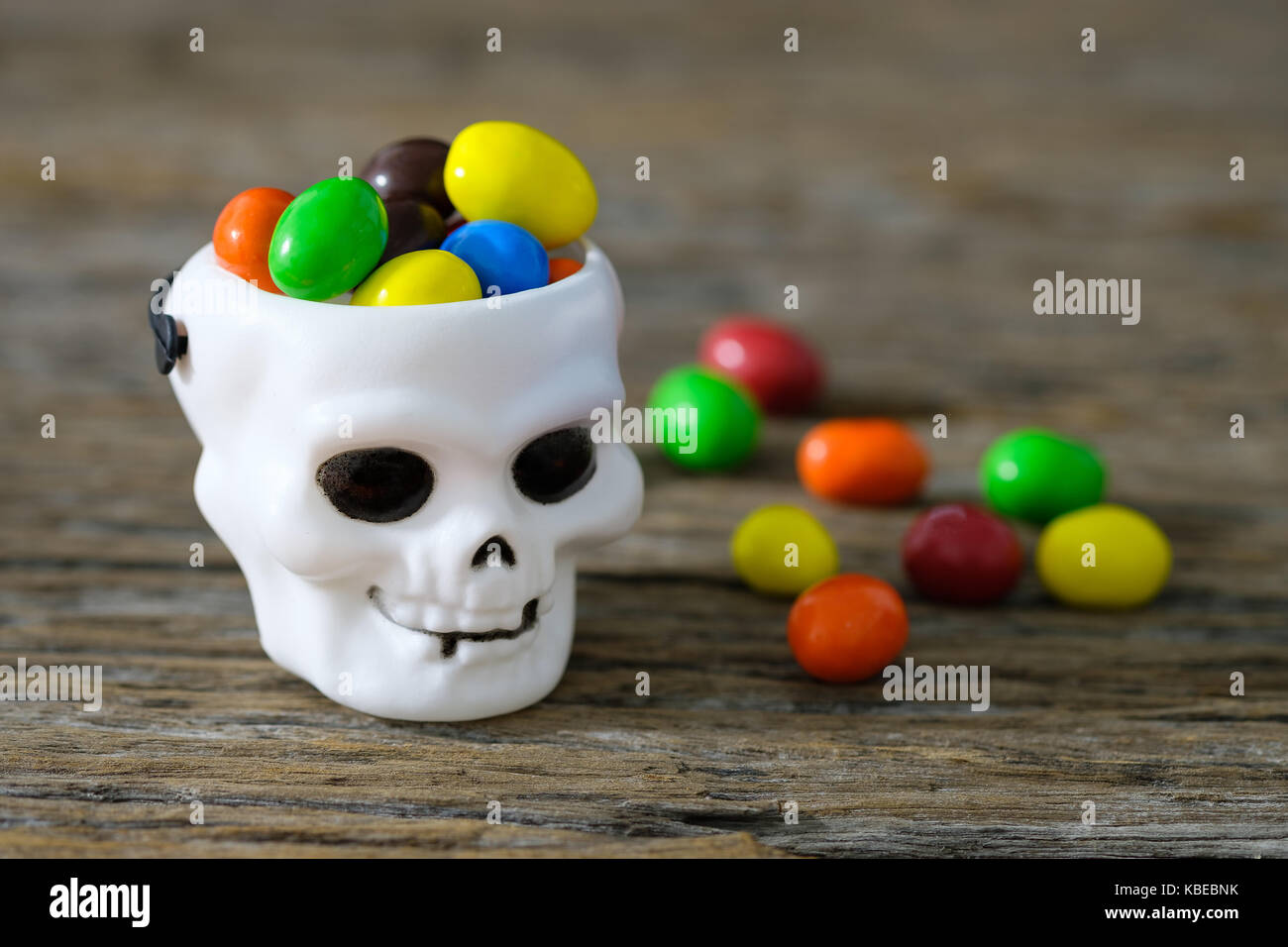 Candy colors contained in the tank white cranium skull Stock Photo - Alamy