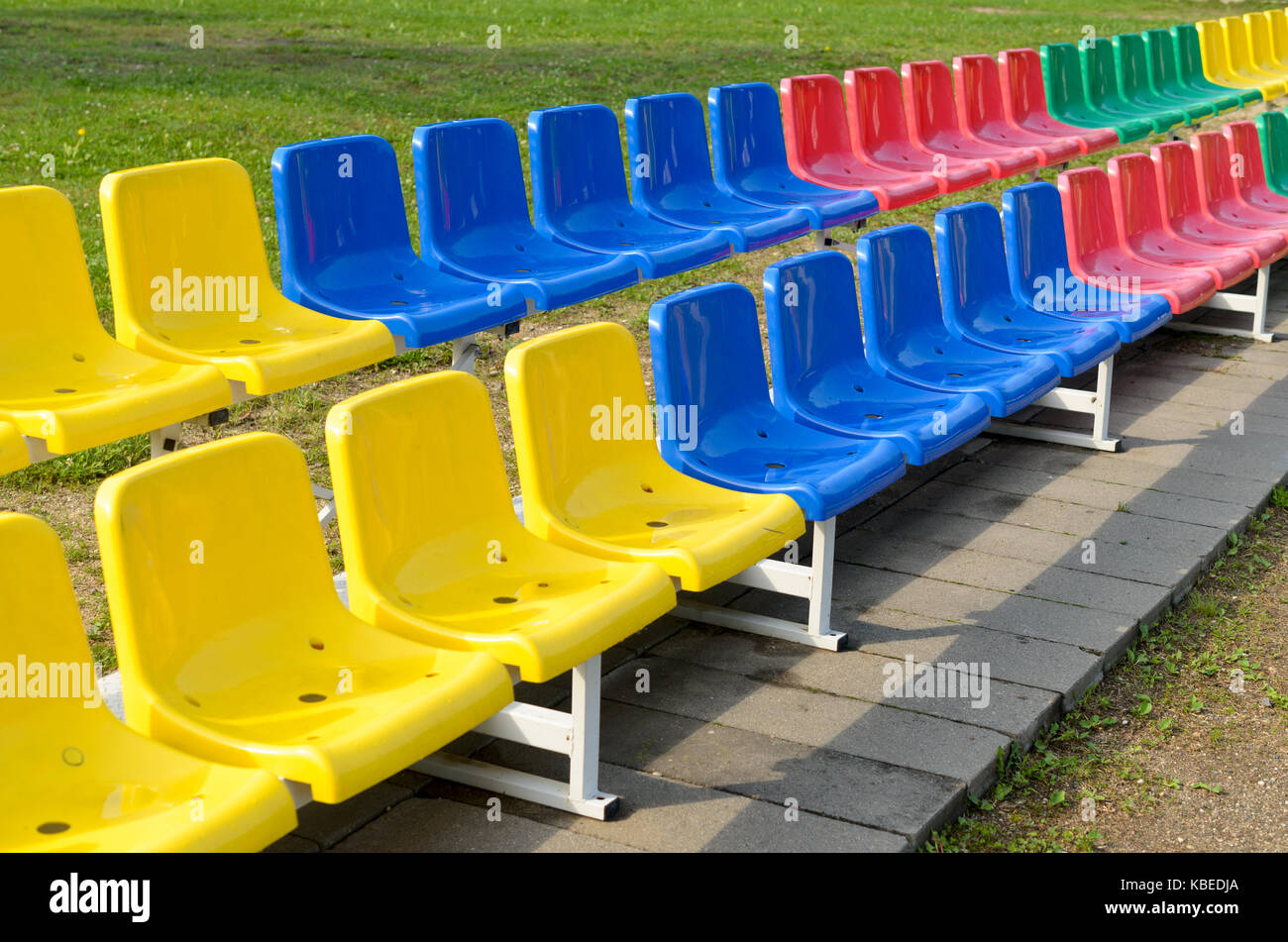 Multicolored benches for sports fans standing in two rows Stock Photo ...