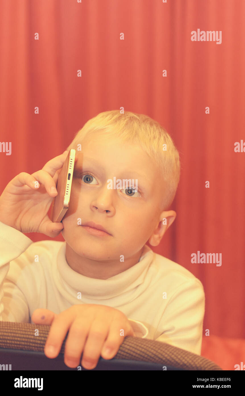 Little boy talking on the phone expressing his emotions Stock Photo - Alamy
