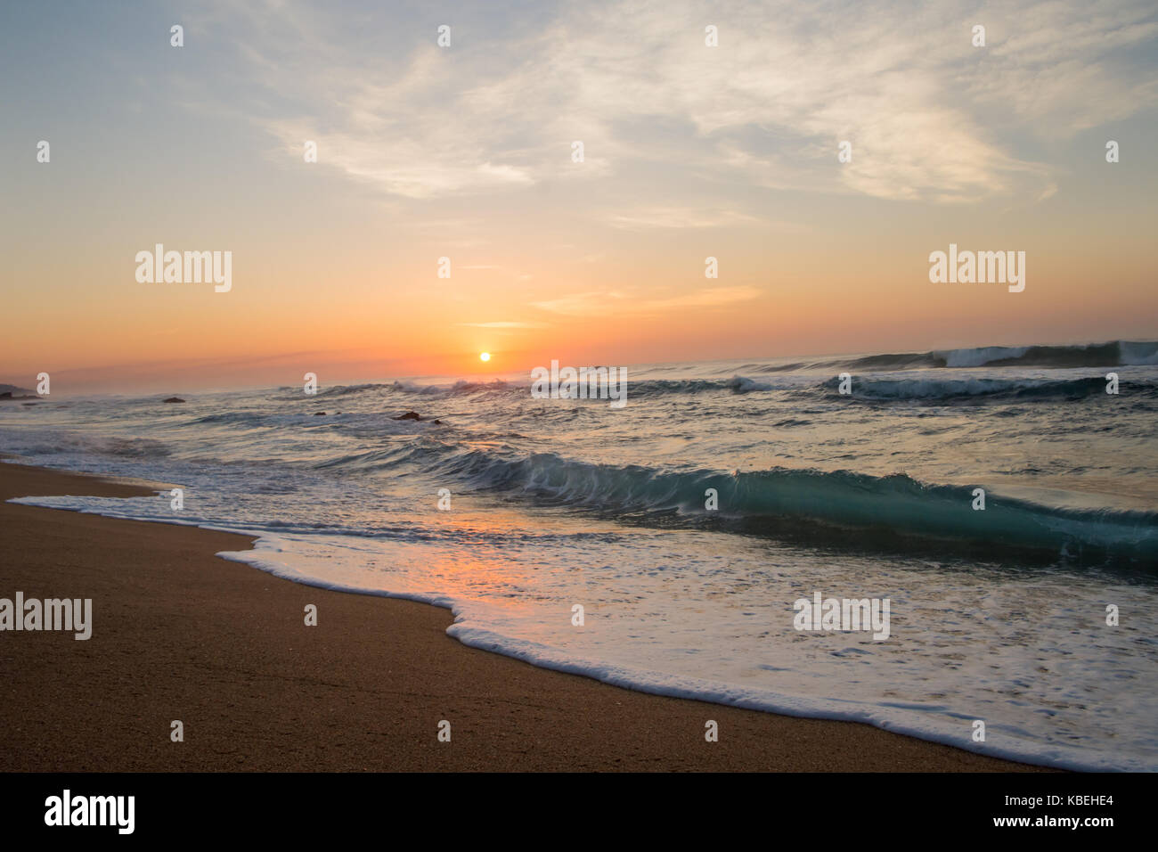 Sunrise over the beach Stock Photo - Alamy