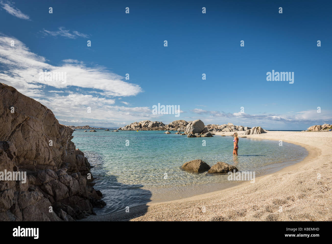 Woman in bikini paddling in the translucent Mediterranean sea just off ...