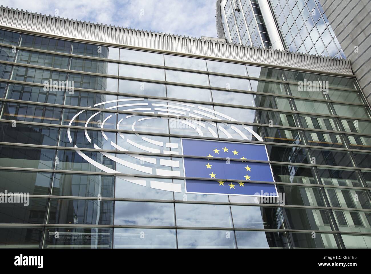Glass facade on the EU Parliaments Building with the European flagg in ...