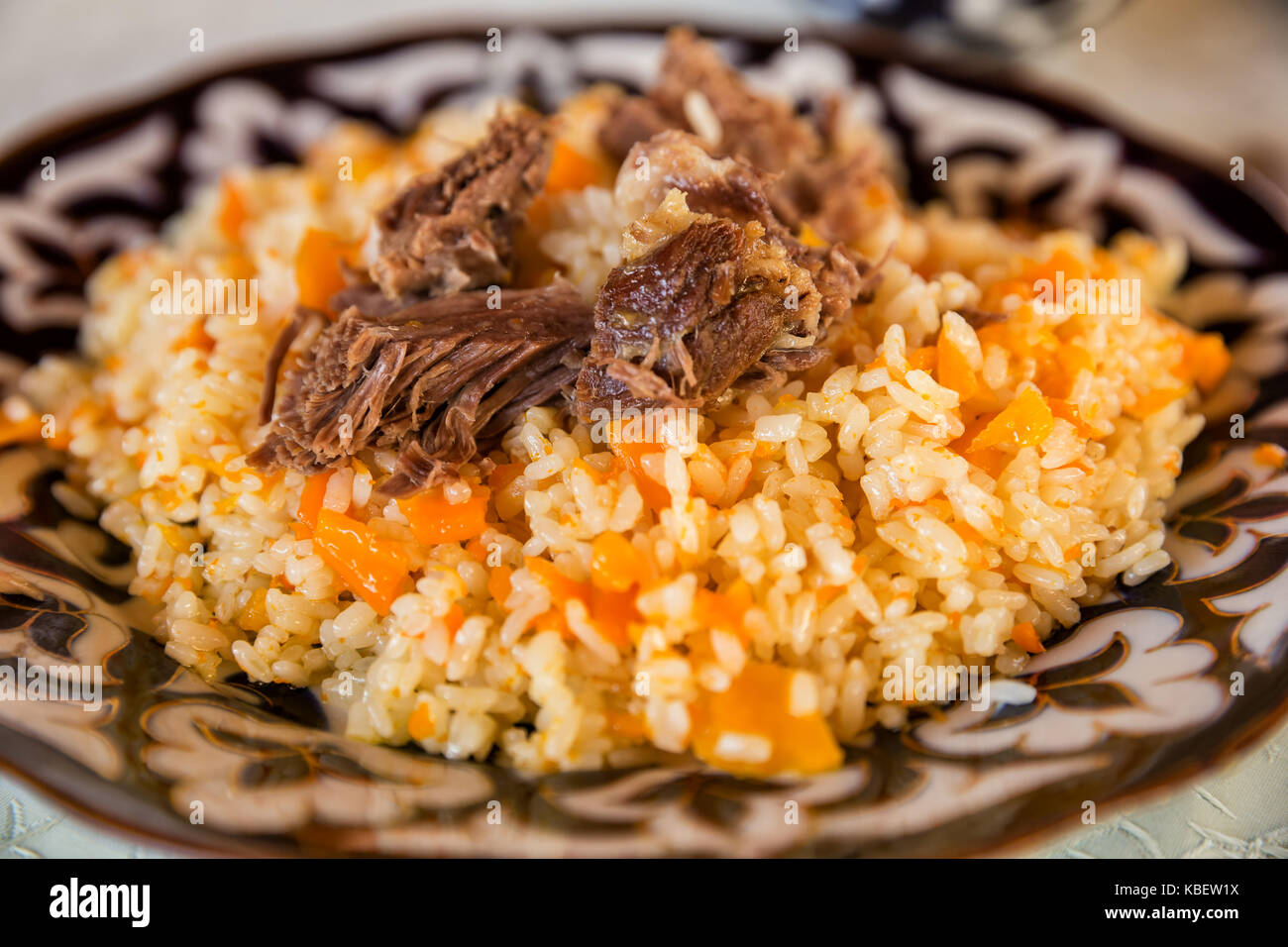 Uzbek pilaf, a traditional dish of Central Asian cuisine, on a plate ...