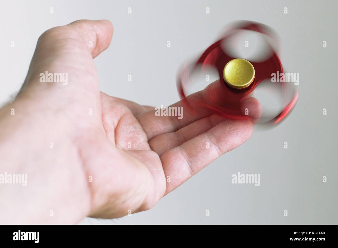 fidget spinner rotating on fingers | usage worldwide Stock Photo - Alamy