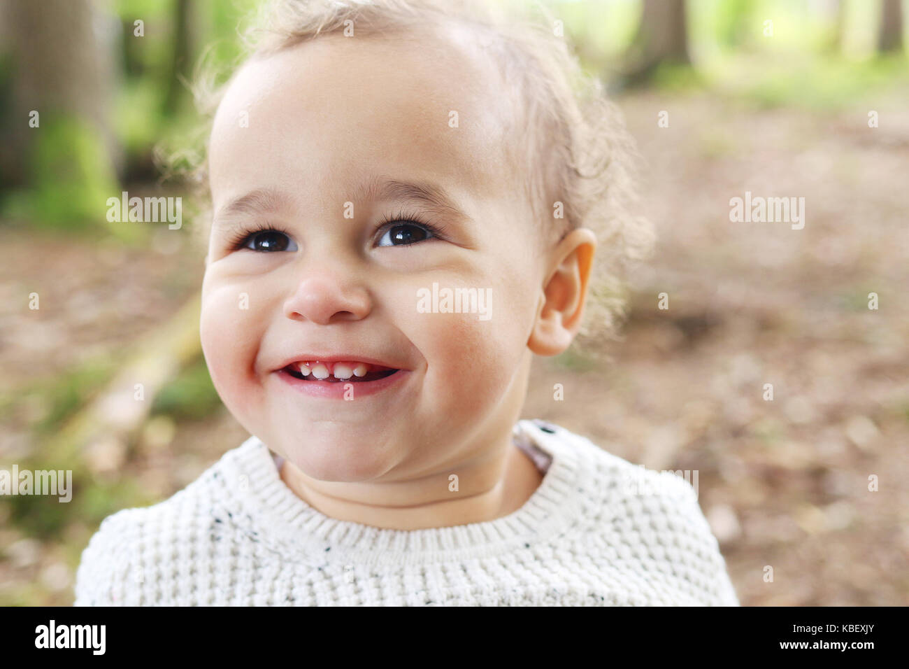 Happy child playing in a forest Stock Photo - Alamy