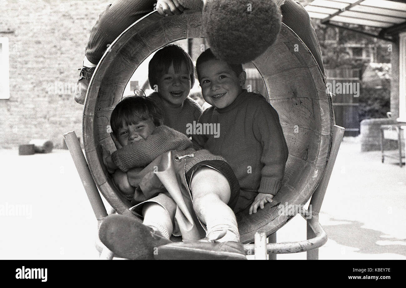 1970s, historical, children having great fun playing together on a ...