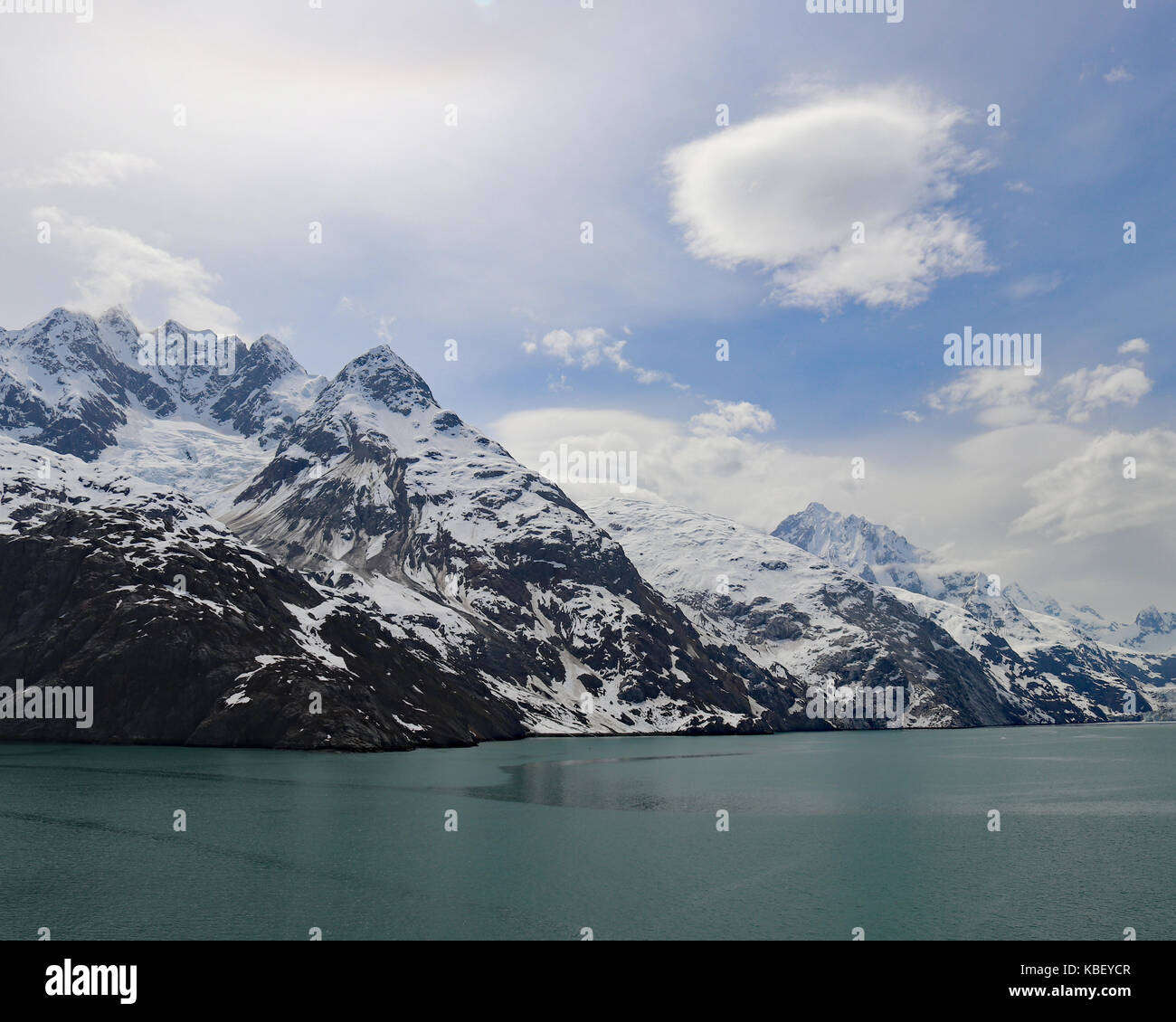 Rugged snow covered mountains surround the John Hopkins glacier in ...