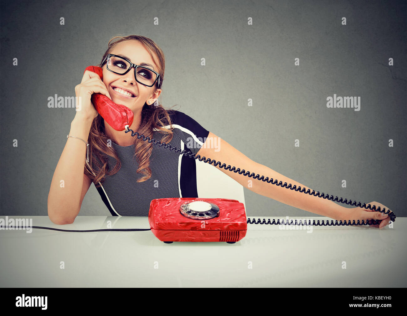 Happy funny looking woman calling someone on the phone Stock Photo - Alamy