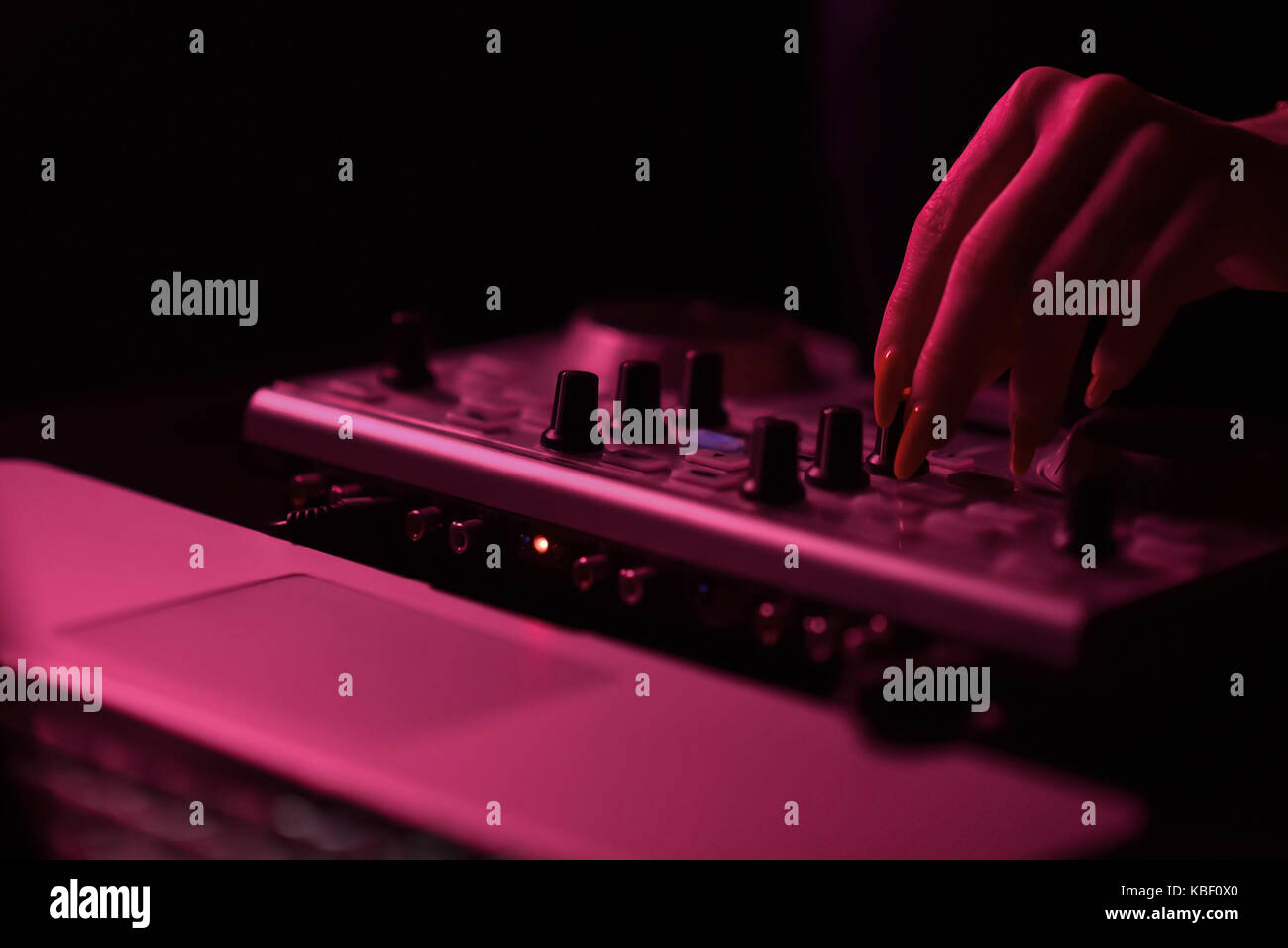 DJ mixer disco illuminated by searchlights Stock Photo - Alamy