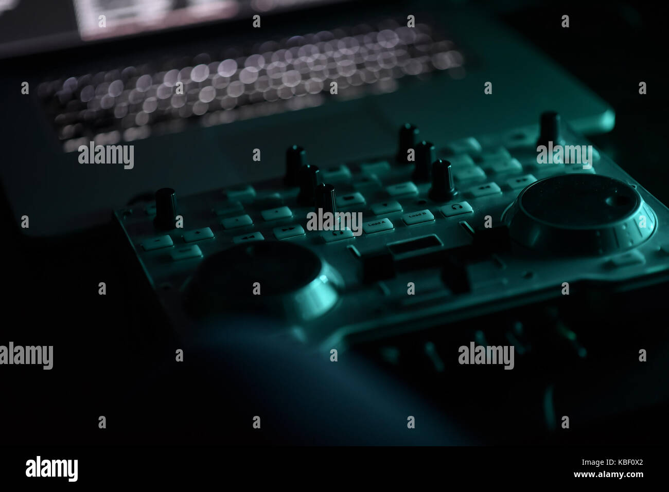 DJ mixer disco illuminated by searchlights Stock Photo - Alamy