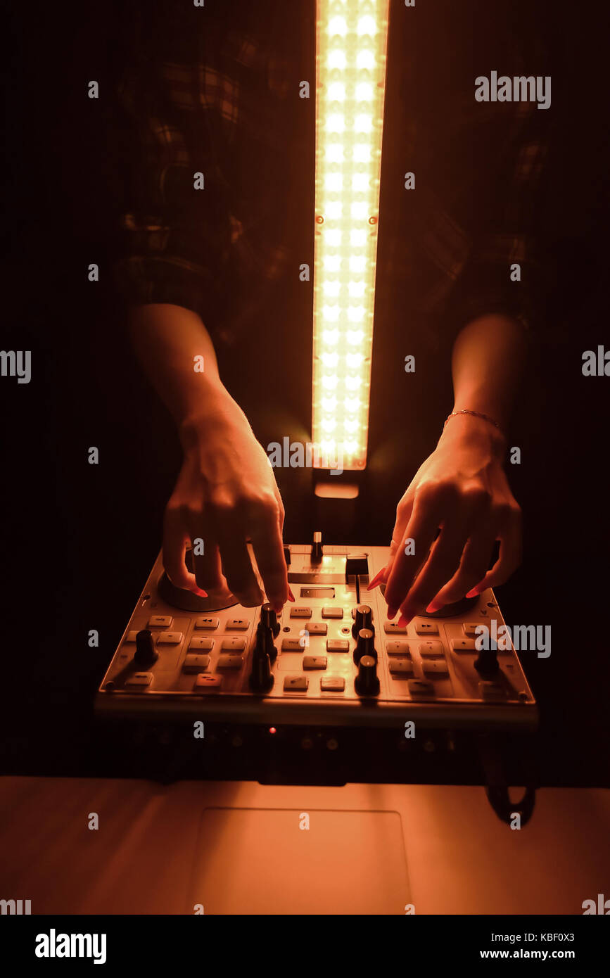 DJ mixer disco illuminated by searchlights Stock Photo - Alamy