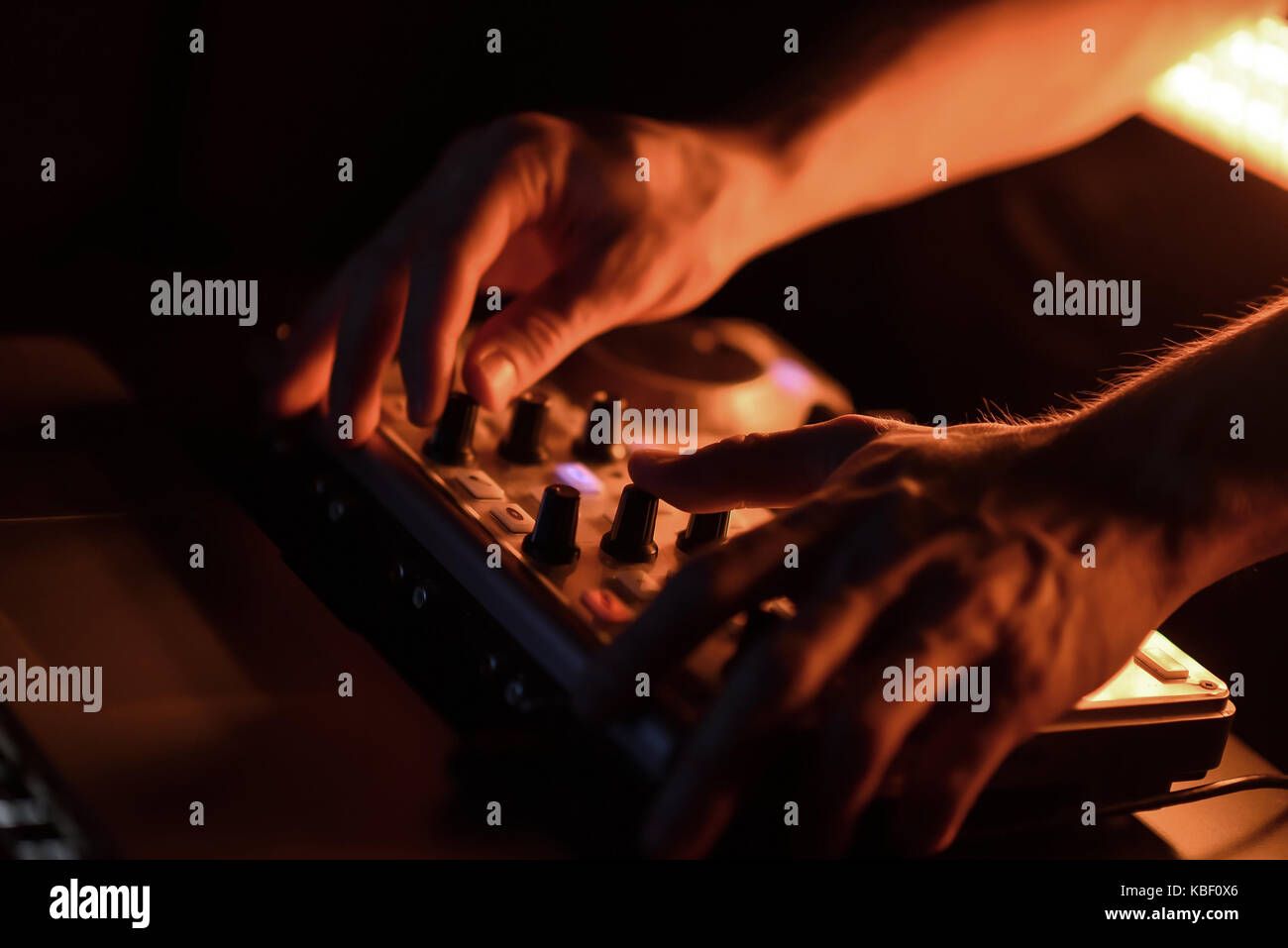 DJ mixer disco illuminated by searchlights Stock Photo - Alamy