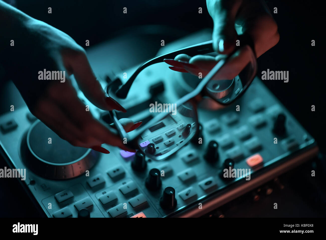 DJ mixer disco illuminated by searchlights Stock Photo - Alamy