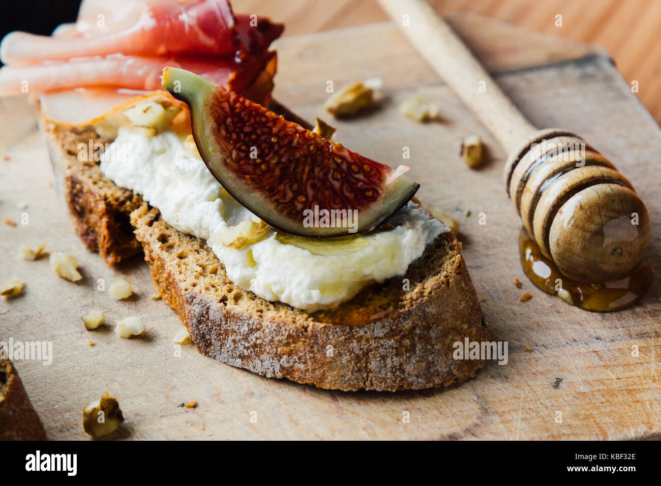 rustic figs bruschetta with honey on wooden table Stock Photo - Alamy
