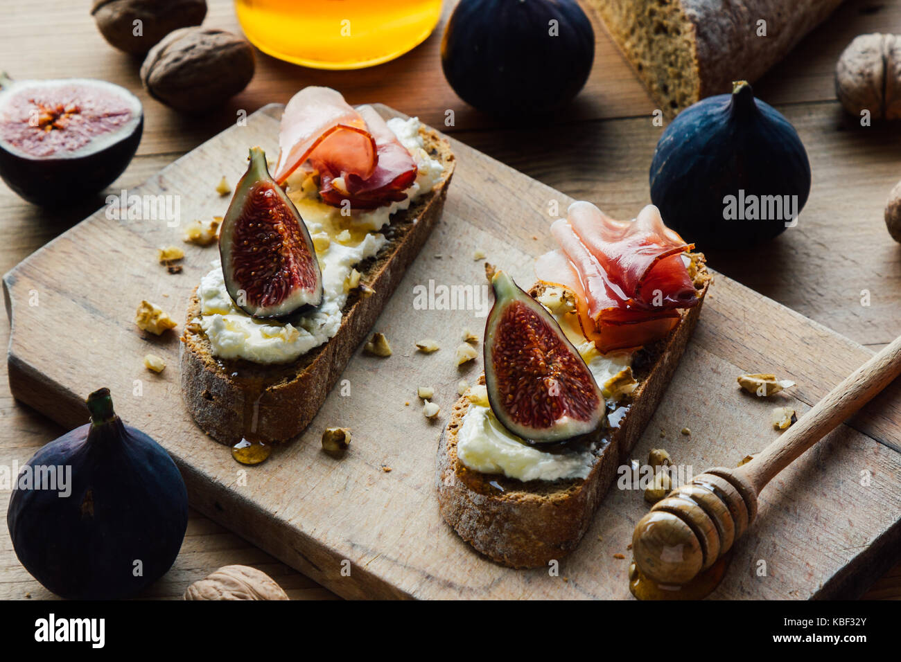 rustic figs bruschetta with honey on wooden table Stock Photo - Alamy