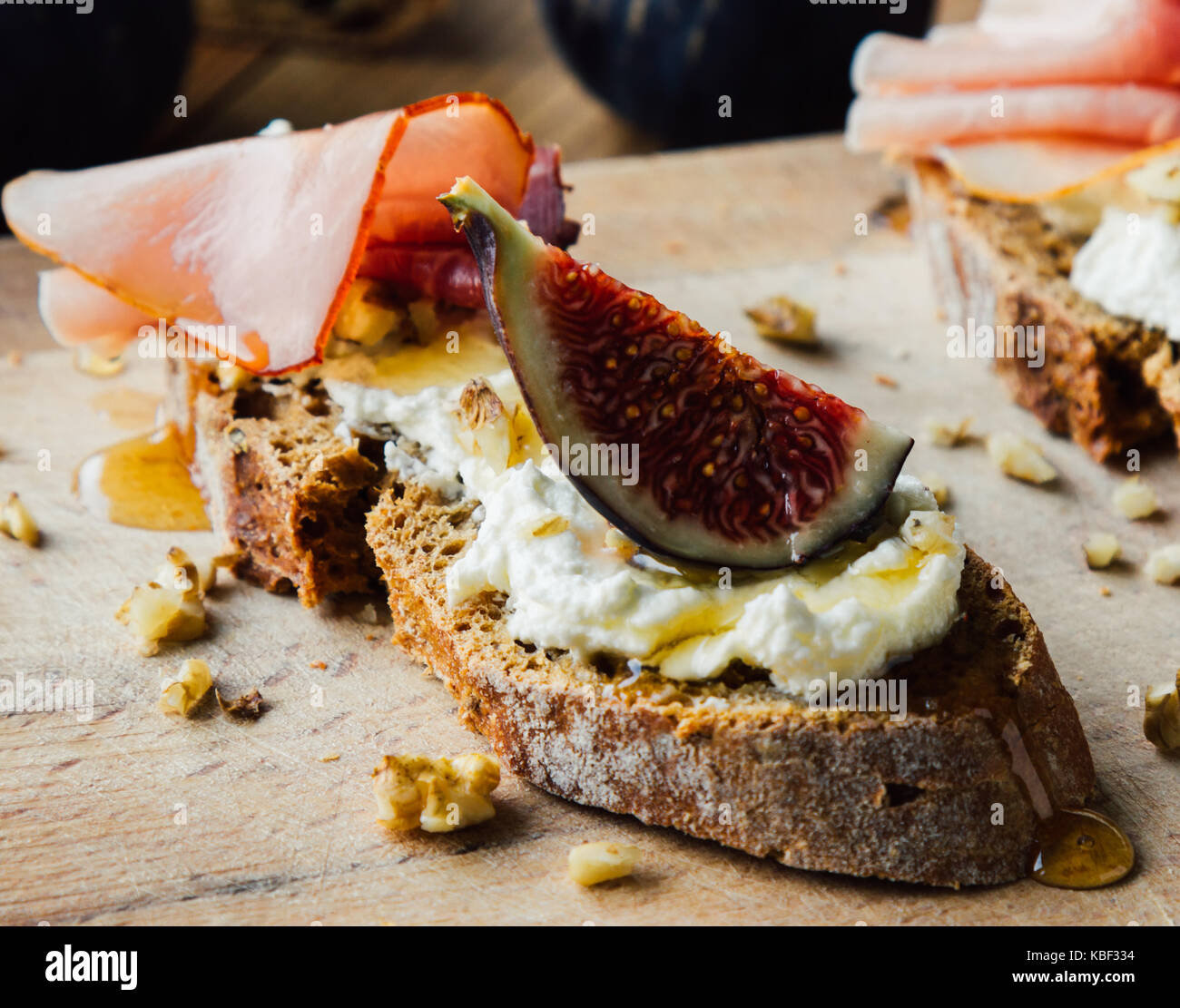 rustic figs bruschetta with honey on wooden table Stock Photo - Alamy