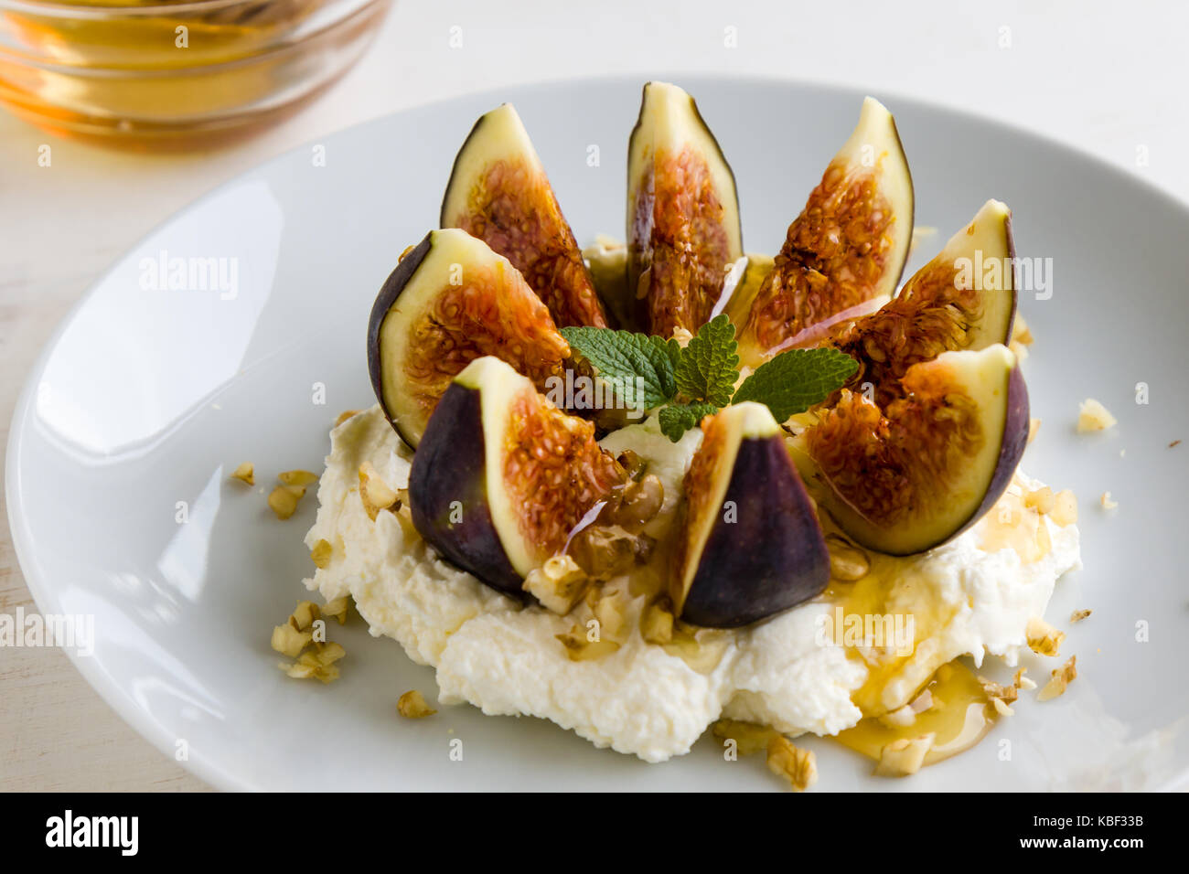 figs dessert with cream cheese, honey and walnuts Stock Photo - Alamy