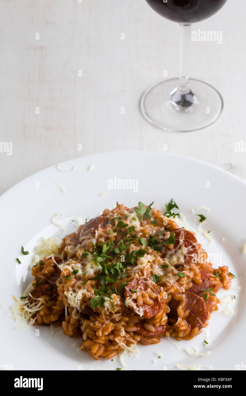 Chorizo risotto with tomato and red wine on white plate Stock Photo - Alamy