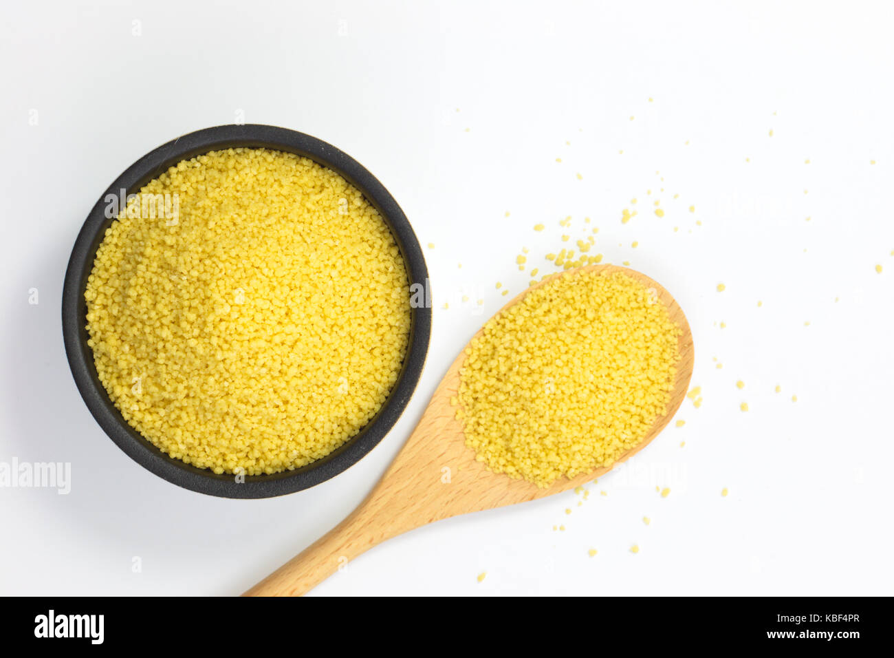 Food concept Raw organic couscous in bowl on white background with copy ...