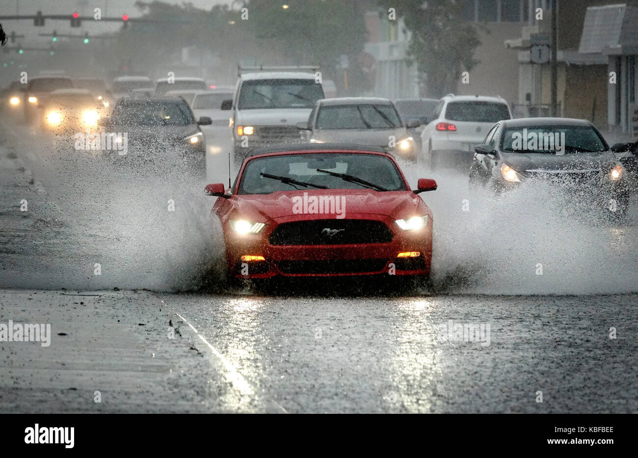 Florida, USA. 29th Sep, 2017. Cars splash through a flooded section of ...