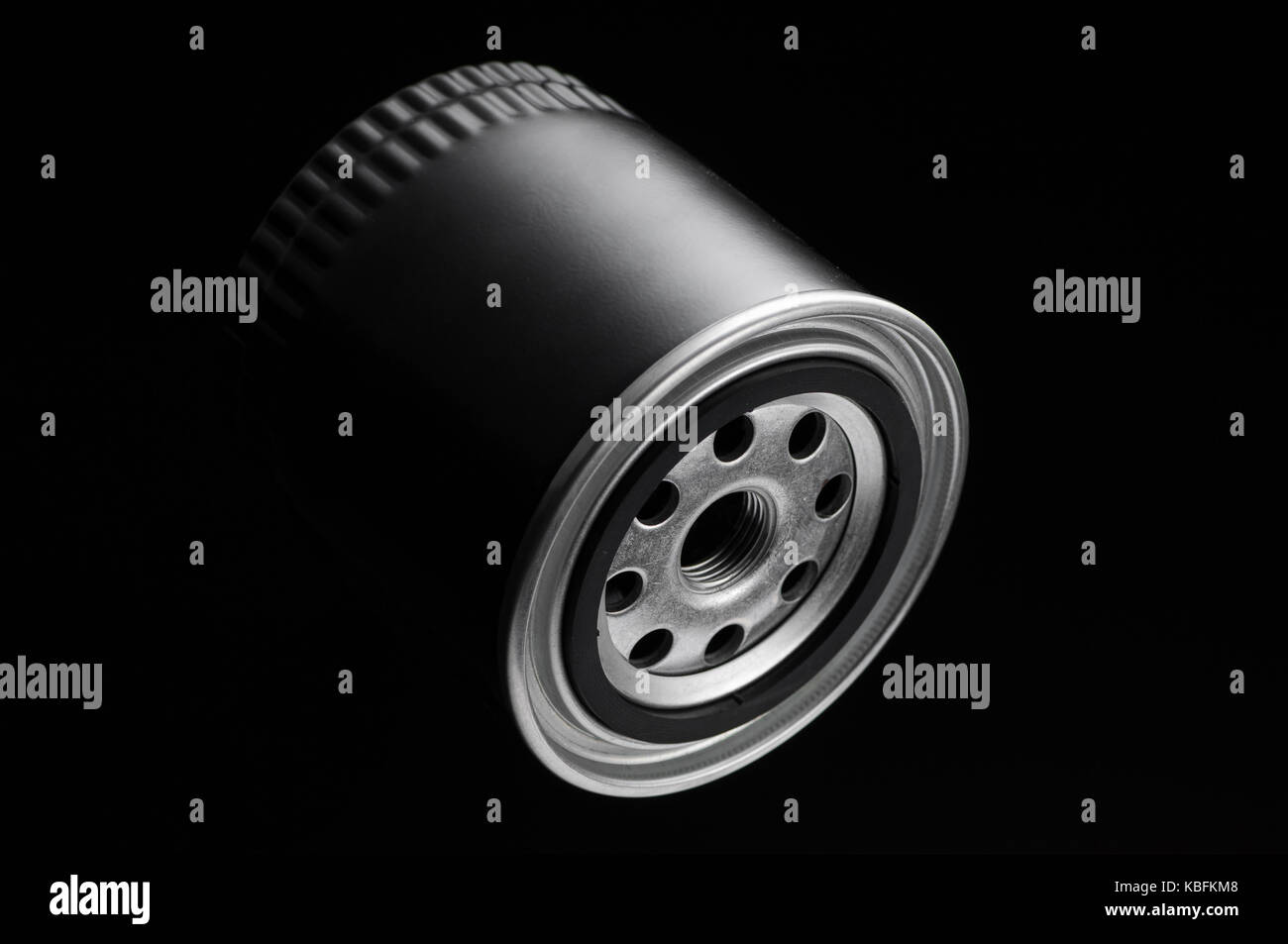 metallic automotive filter cylindrical shape on a black background ...