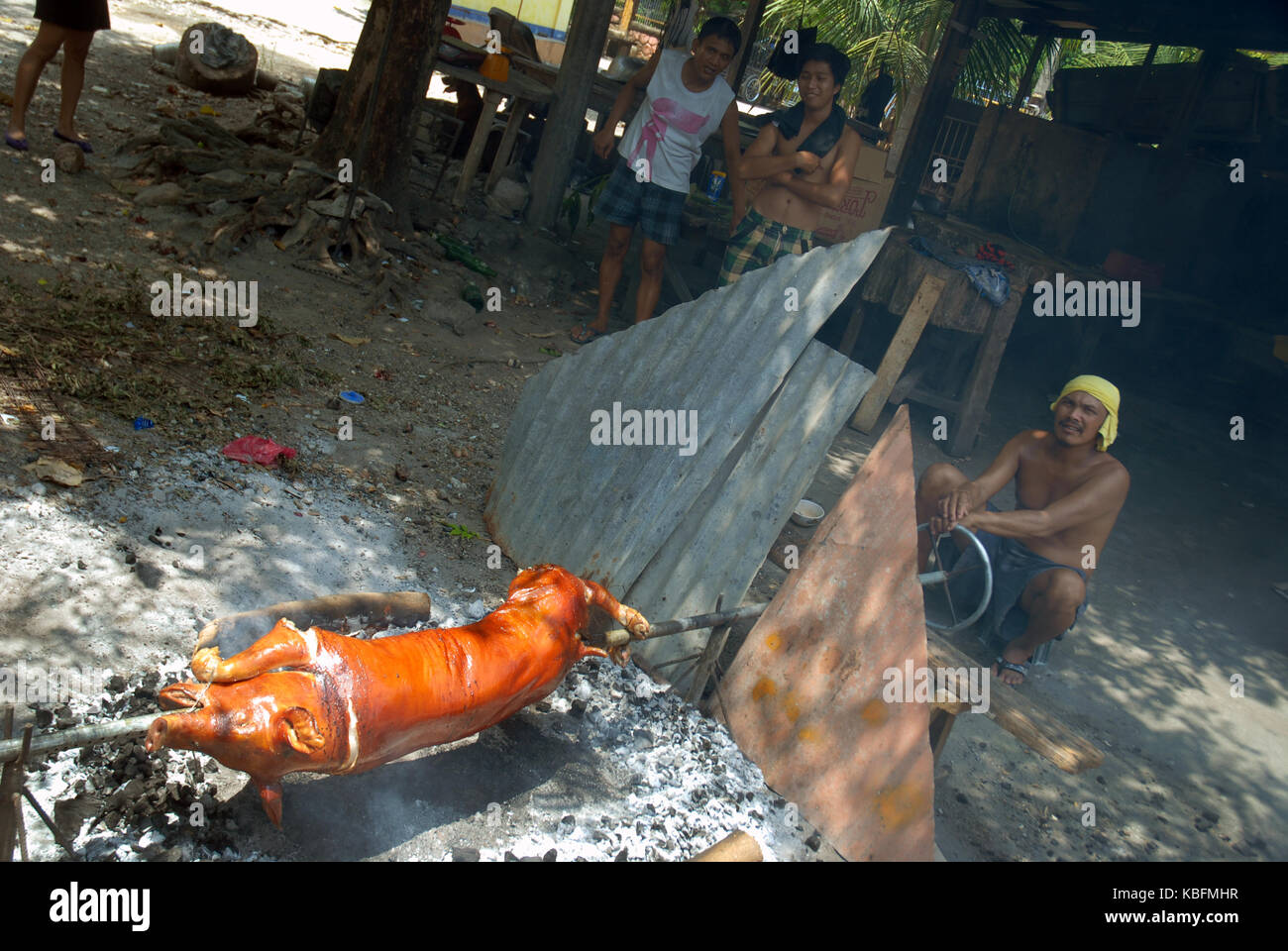 Cooking a pig on a spit on an open fire, Angeles, Philippines Stock ...