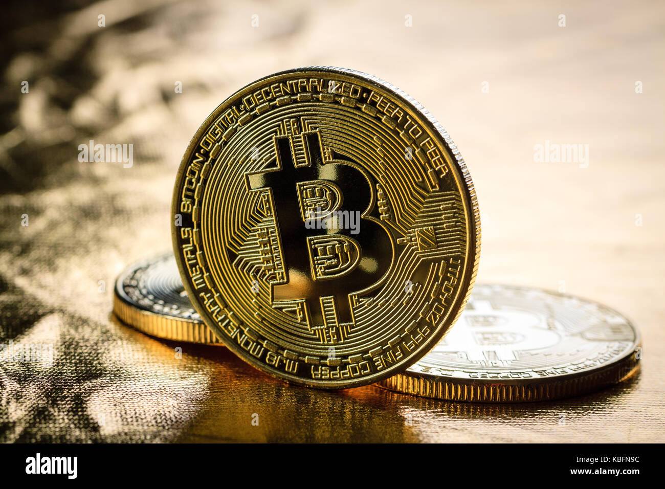 Bitcoin coins on gold colour background Stock Photo - Alamy