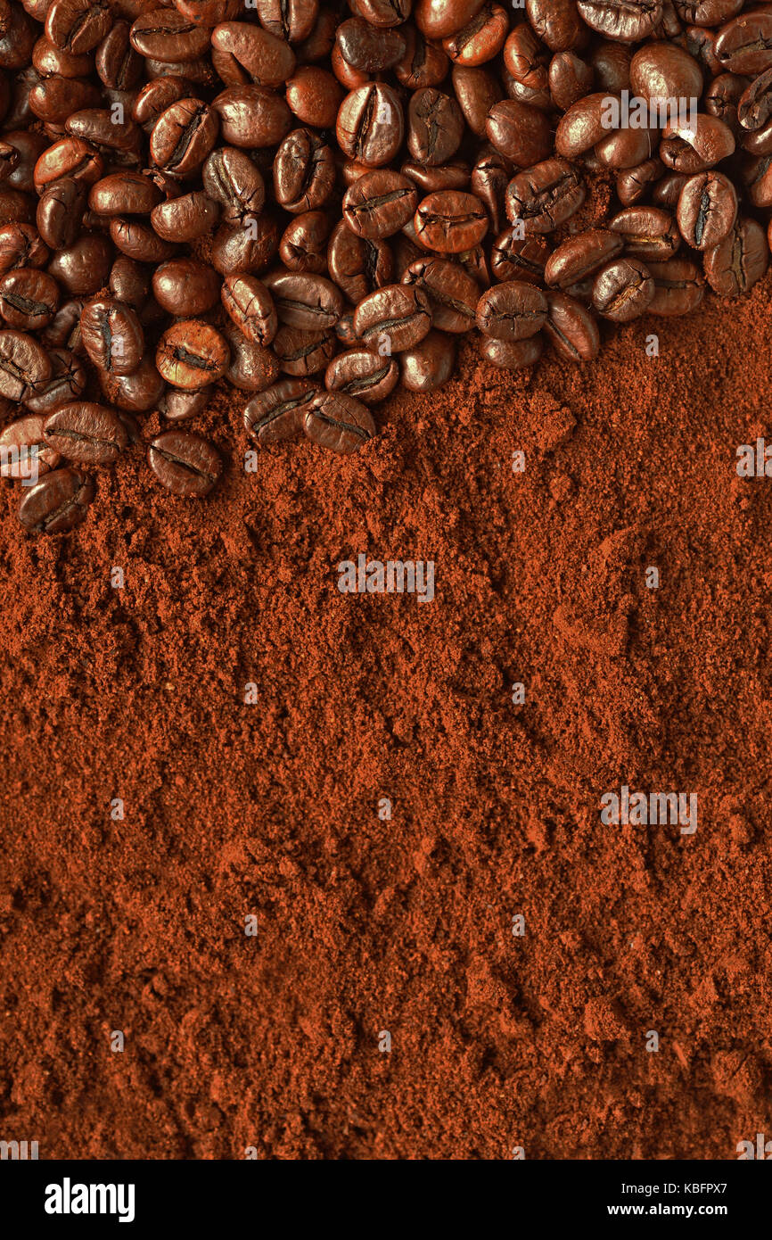 Coffee beans on coffee powder background Stock Photo - Alamy