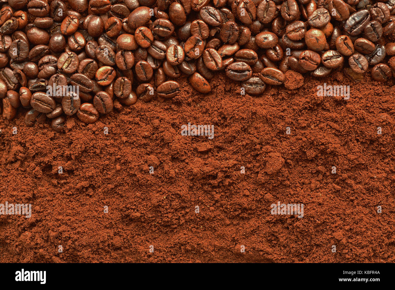 Coffee beans on coffee powder background Stock Photo - Alamy