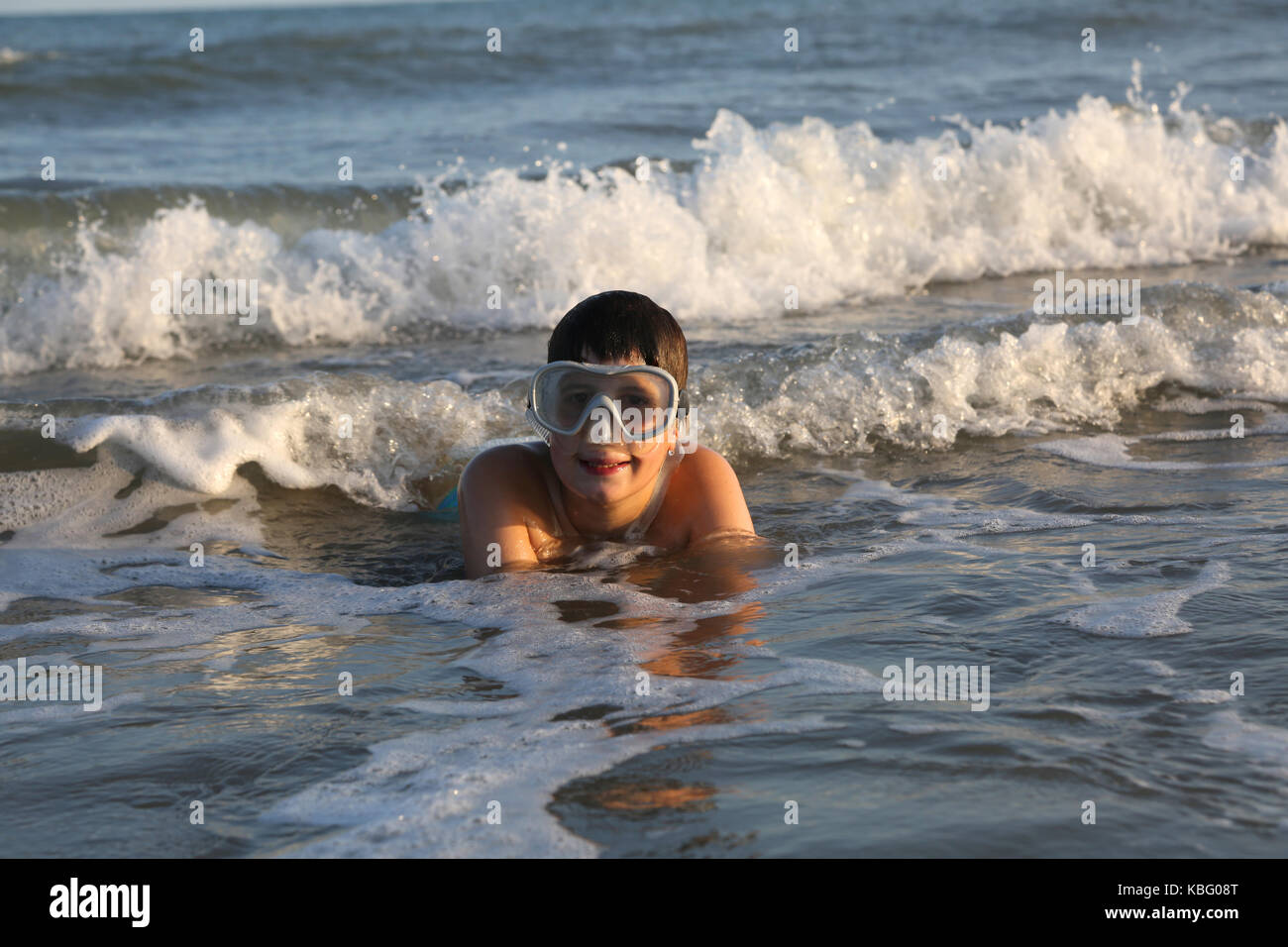 happy child plays diving in the sea wearing a diving mask Stock Photo ...